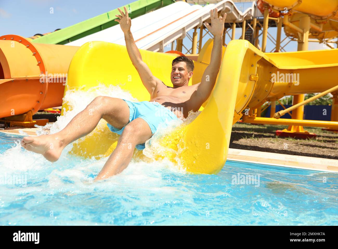 Man on slide at water park. Summer vacation Stock Photo - Alamy