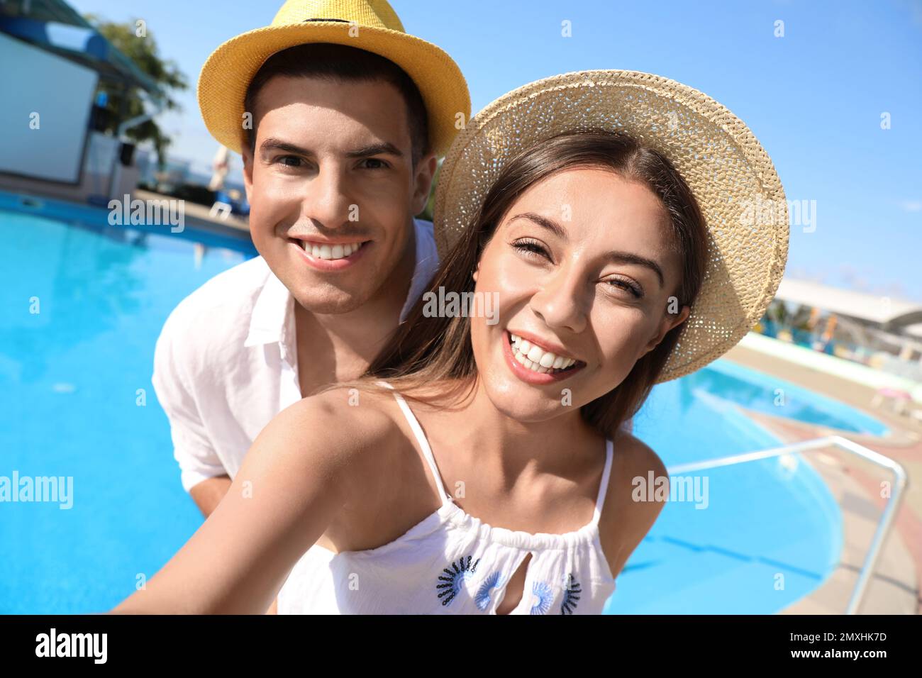 Happy couple taking selfie near swimming pool. Summer vacation Stock ...