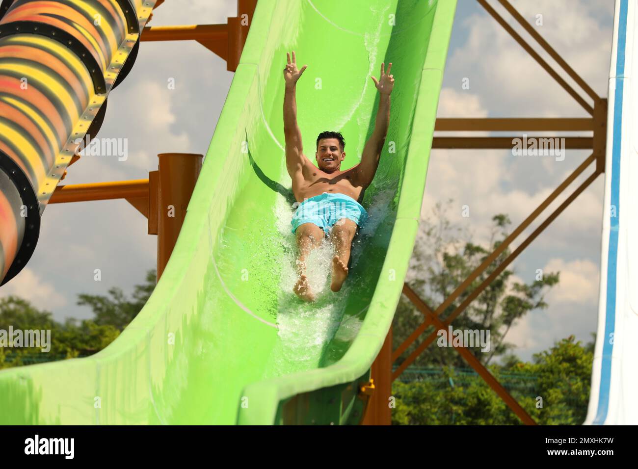 Man on slide at water park. Summer vacation Stock Photo - Alamy