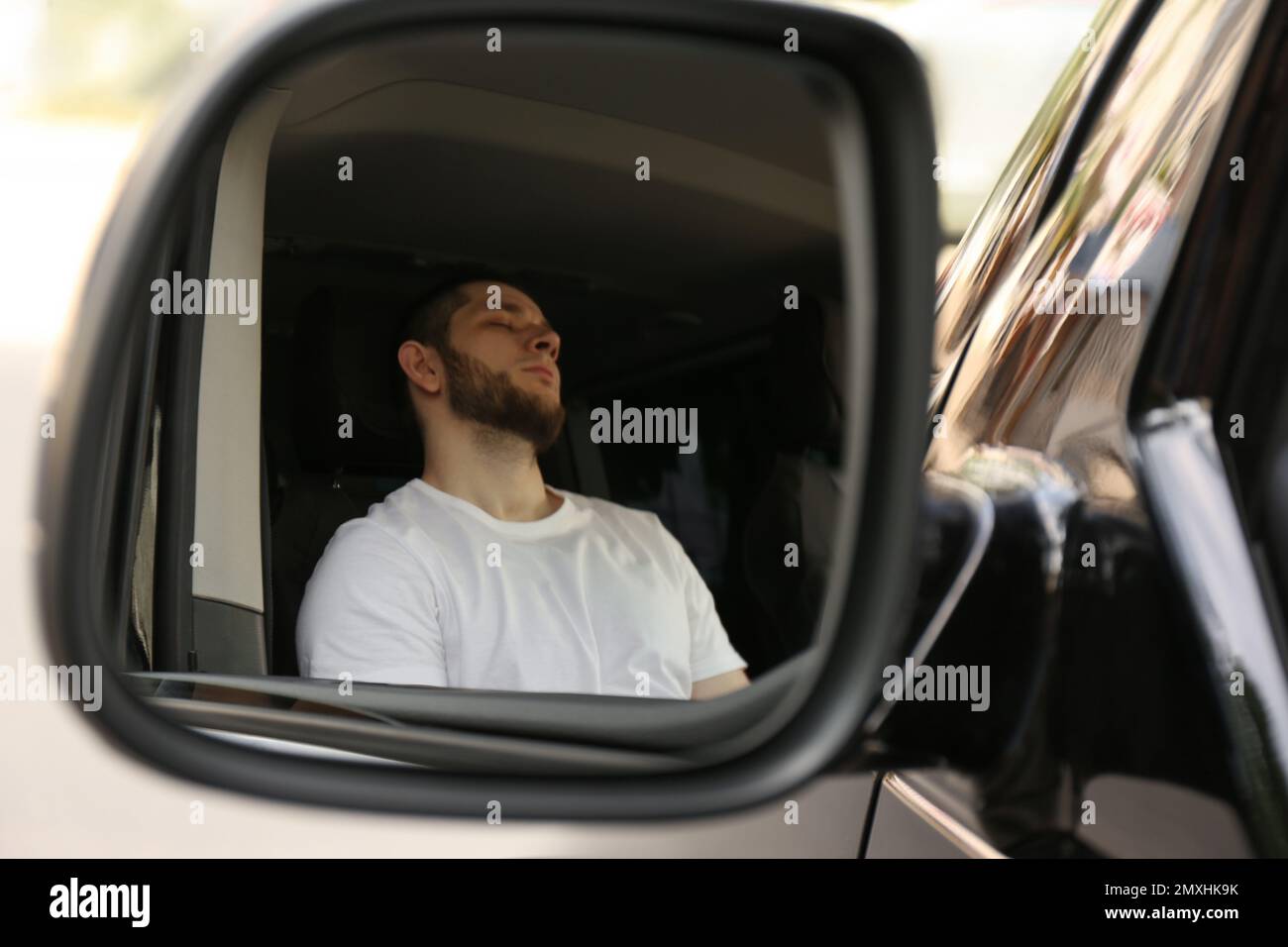 Tired man sleeping in his auto, view through car side mirror Stock ...