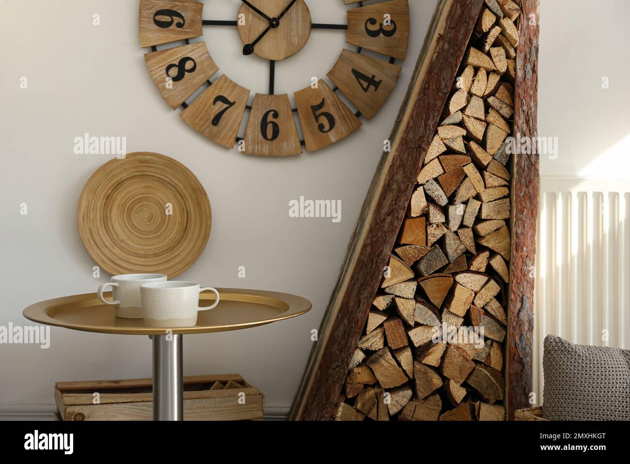 Firewood as decorative element in stylish room interior Stock Photo - Alamy