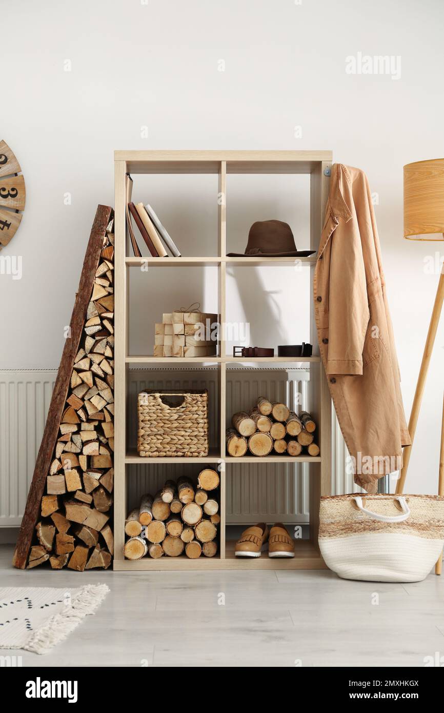 Stylish room interior with firewood as decorative element Stock Photo ...