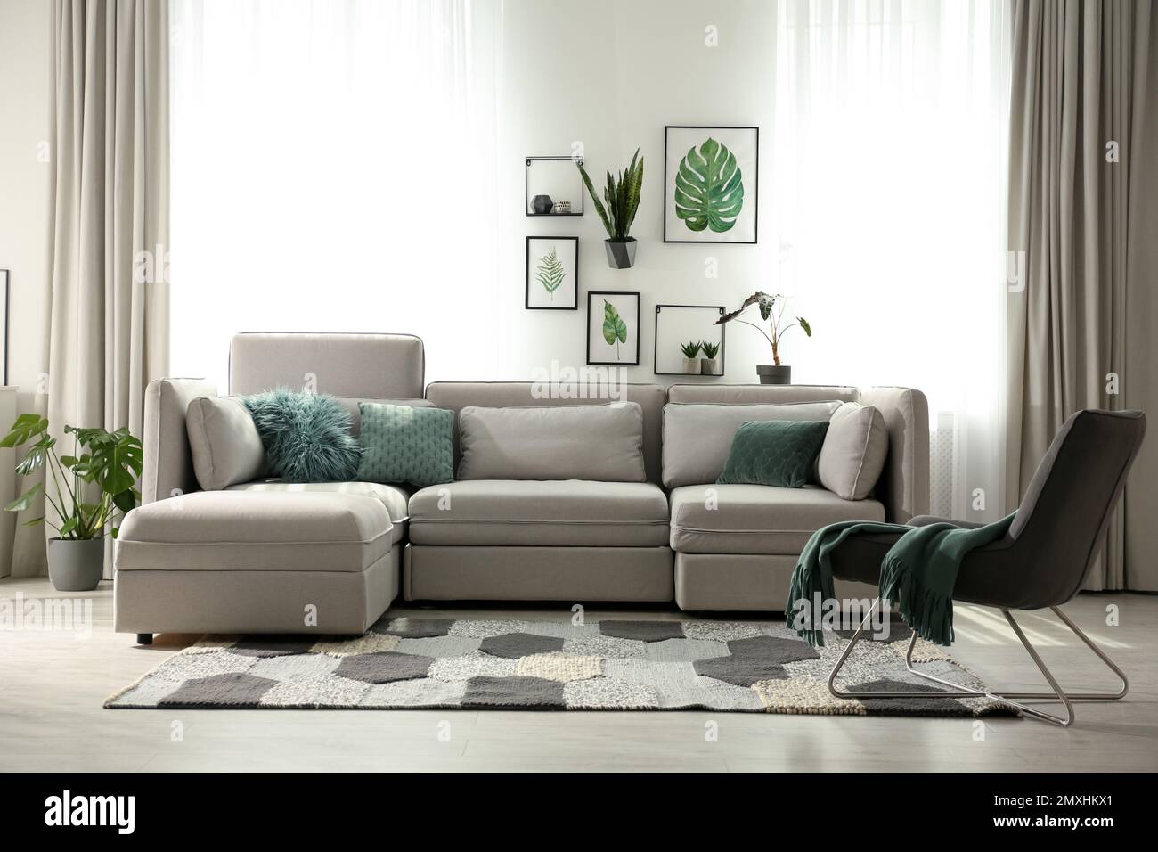 Comfortable large sofa in light room. Interior design Stock Photo - Alamy