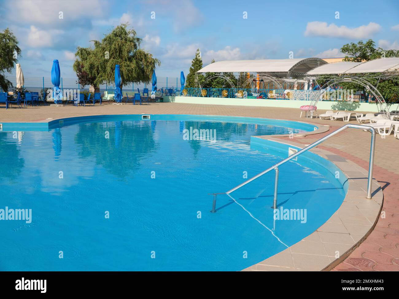 Outdoor swimming pool with clear water on sunny day. Summer vacation ...