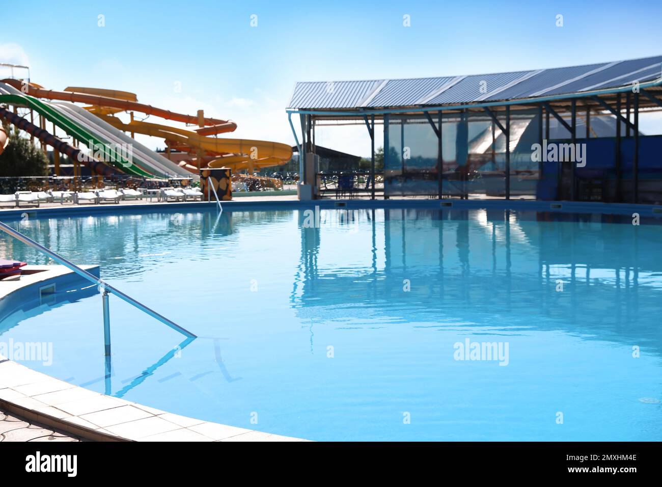 Outdoor swimming pool with clear water on sunny day. Summer vacation ...