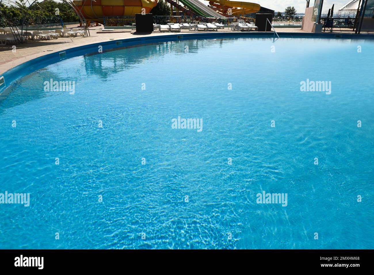 Outdoor swimming pool with clear water on sunny day. Summer vacation ...