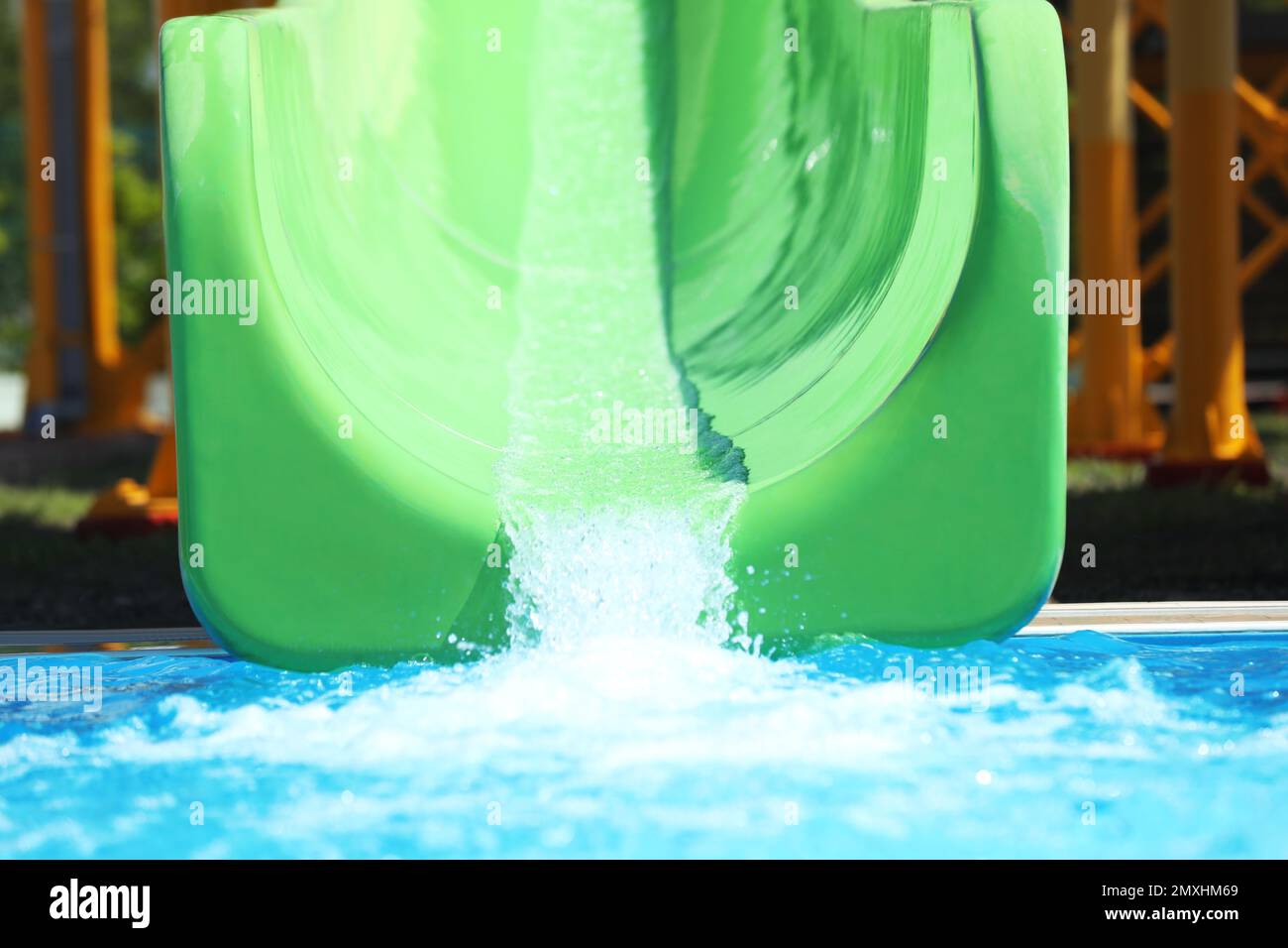 Green slide in water park. Summer vacation Stock Photo - Alamy