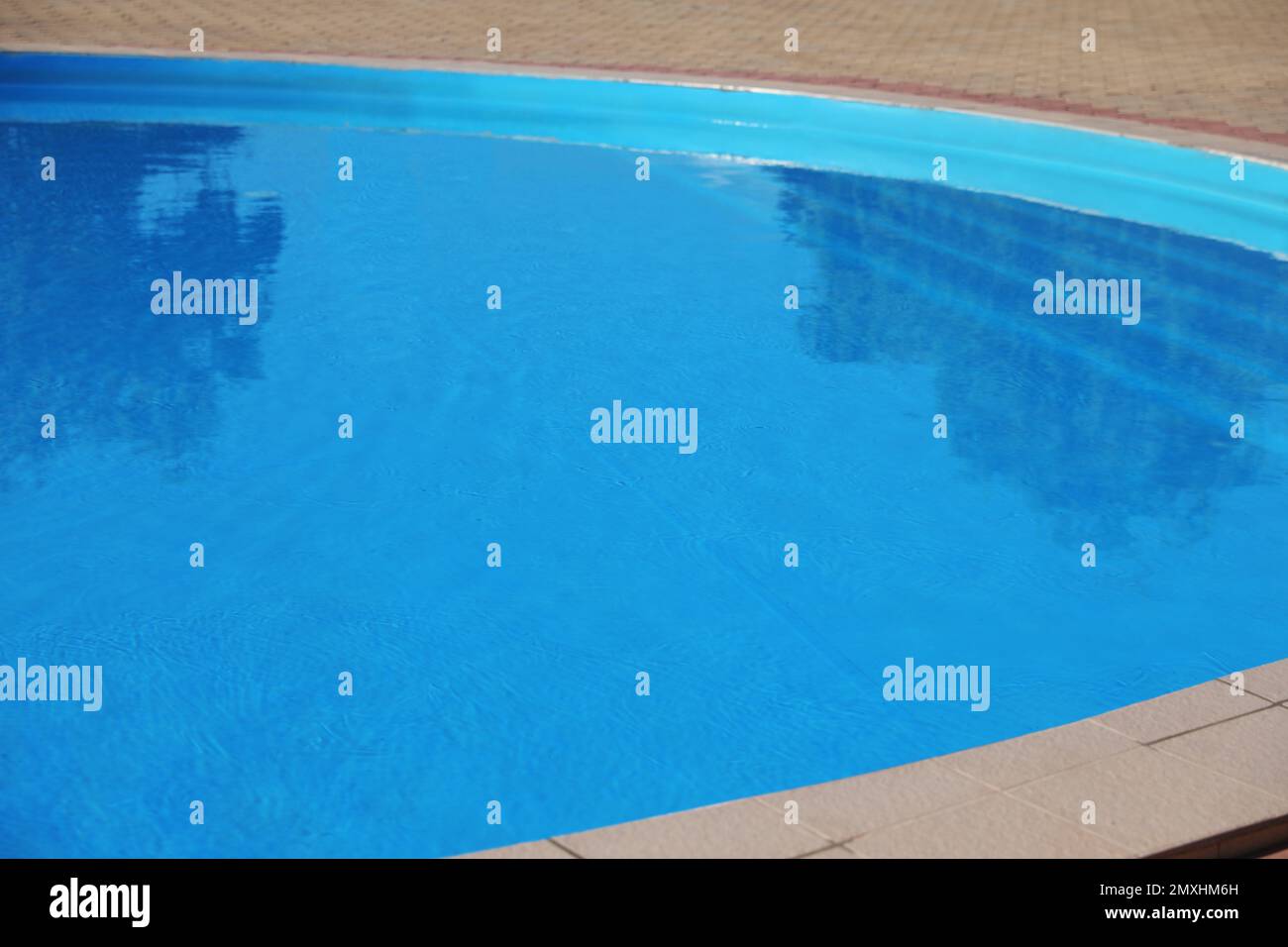 Outdoor swimming pool with clear water on sunny day. Summer vacation ...