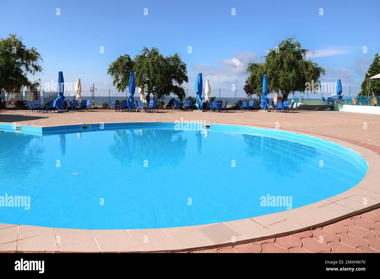 Outdoor swimming pool with clear water on sunny day. Summer vacation ...