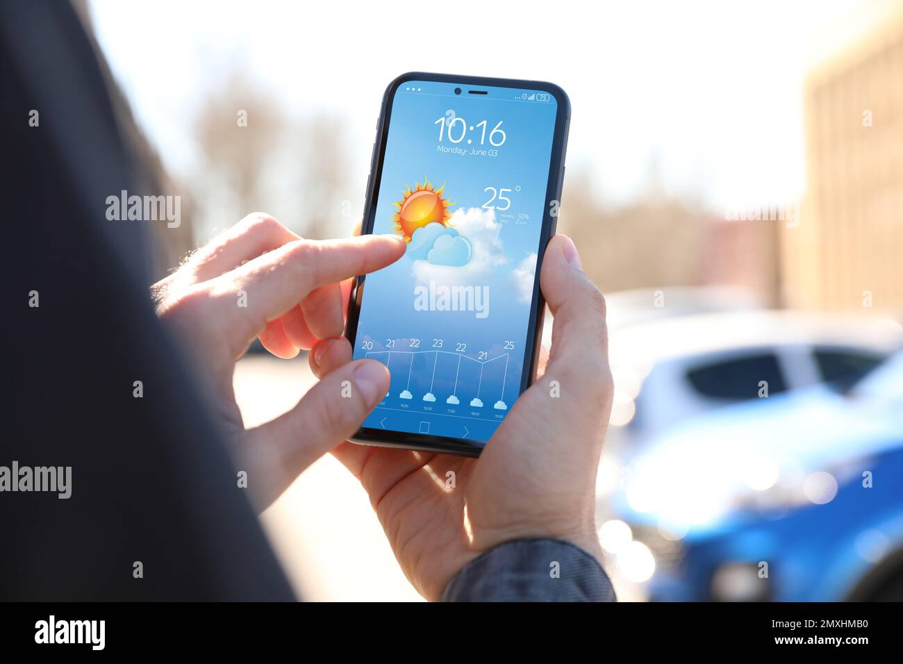 Man using weather forecast app on smartphone outdoors, closeup Stock ...