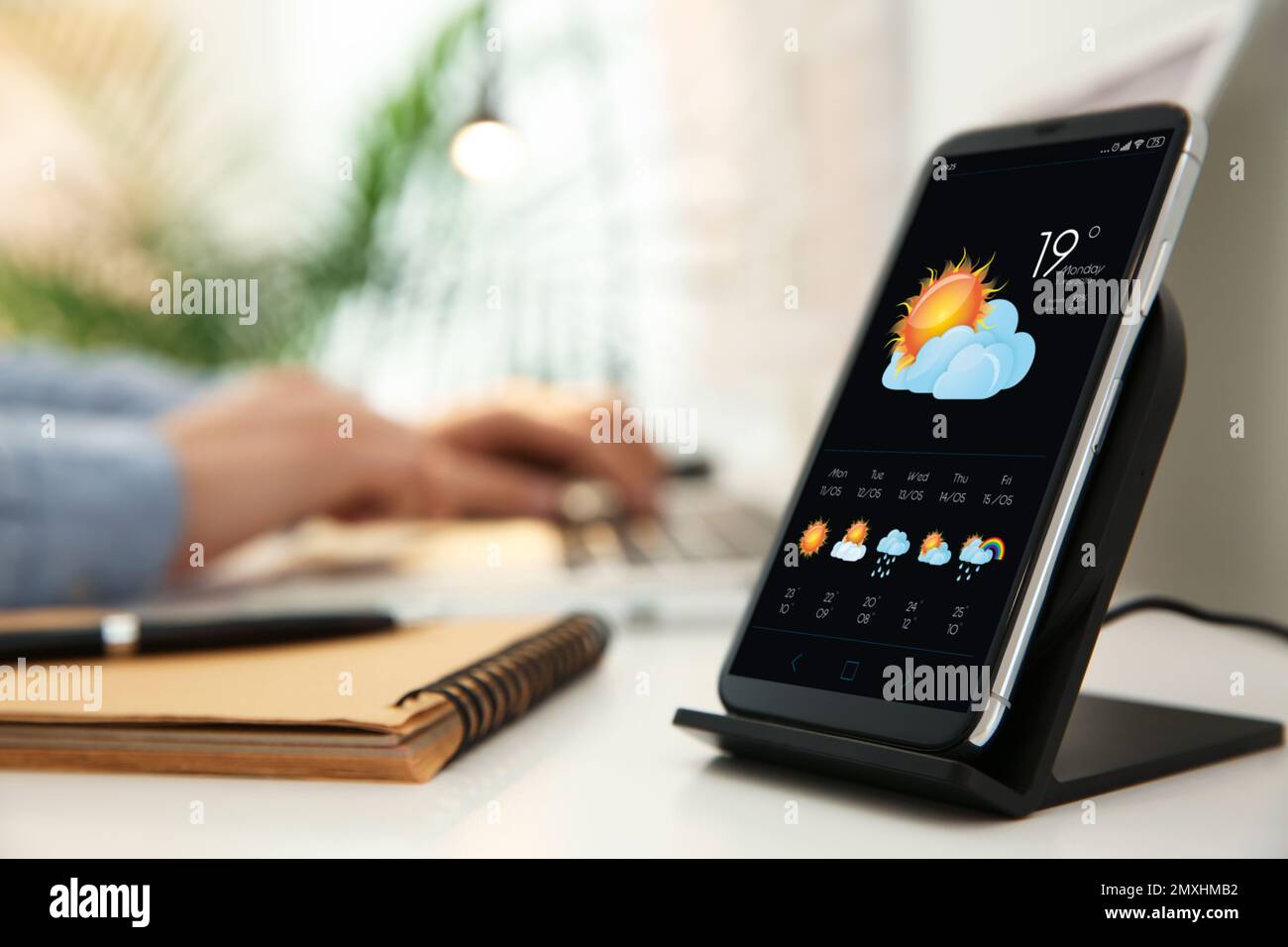 Smartphone with open weather forecast app on white table indoors Stock ...