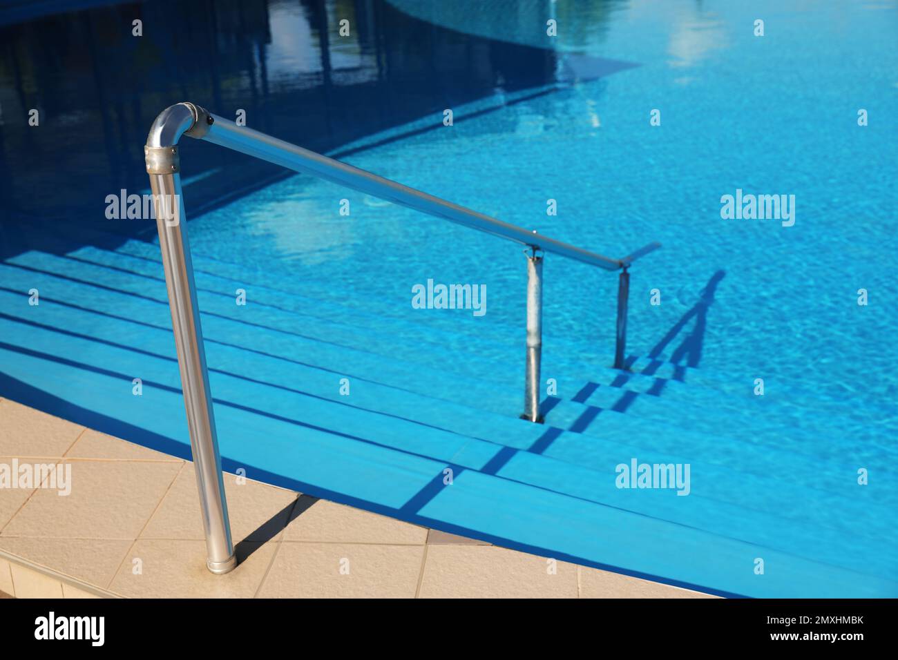 Outdoor swimming pool with clear water on sunny day. Summer vacation ...