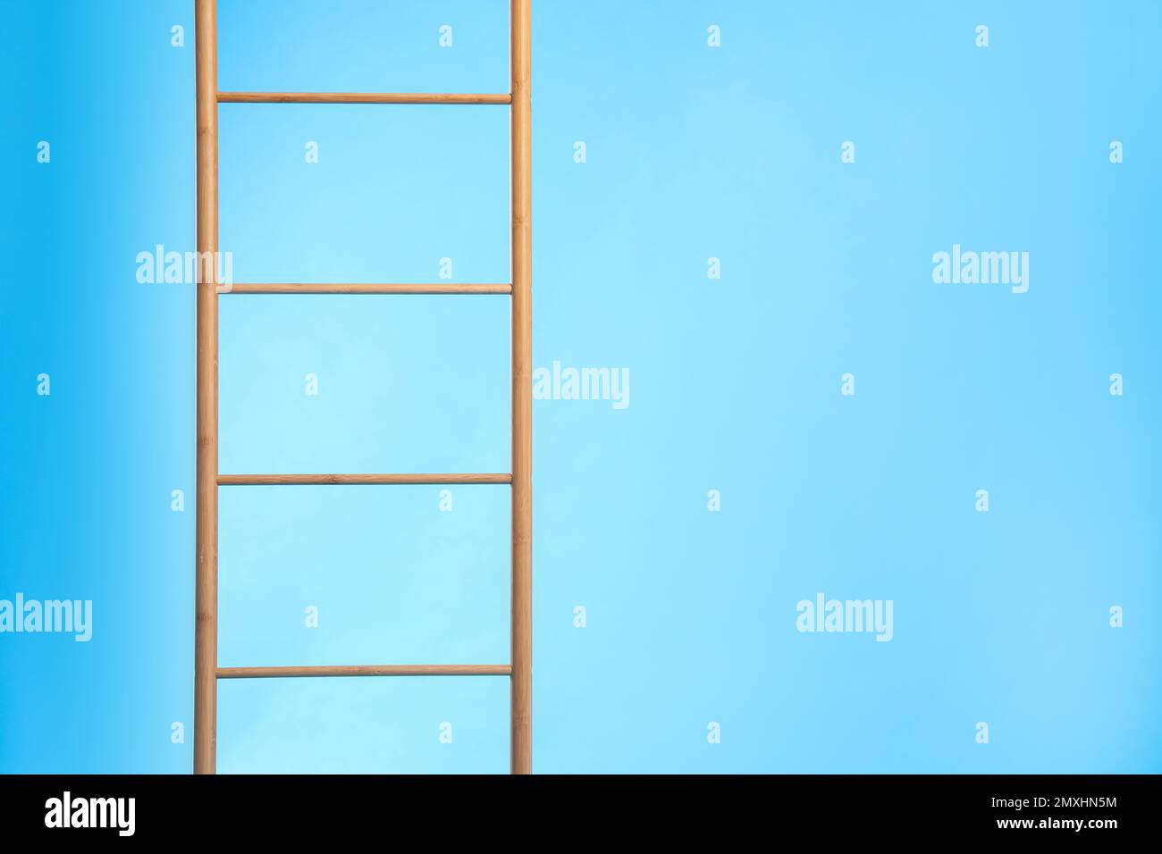 Modern wooden ladder on light blue background. Space for text Stock ...