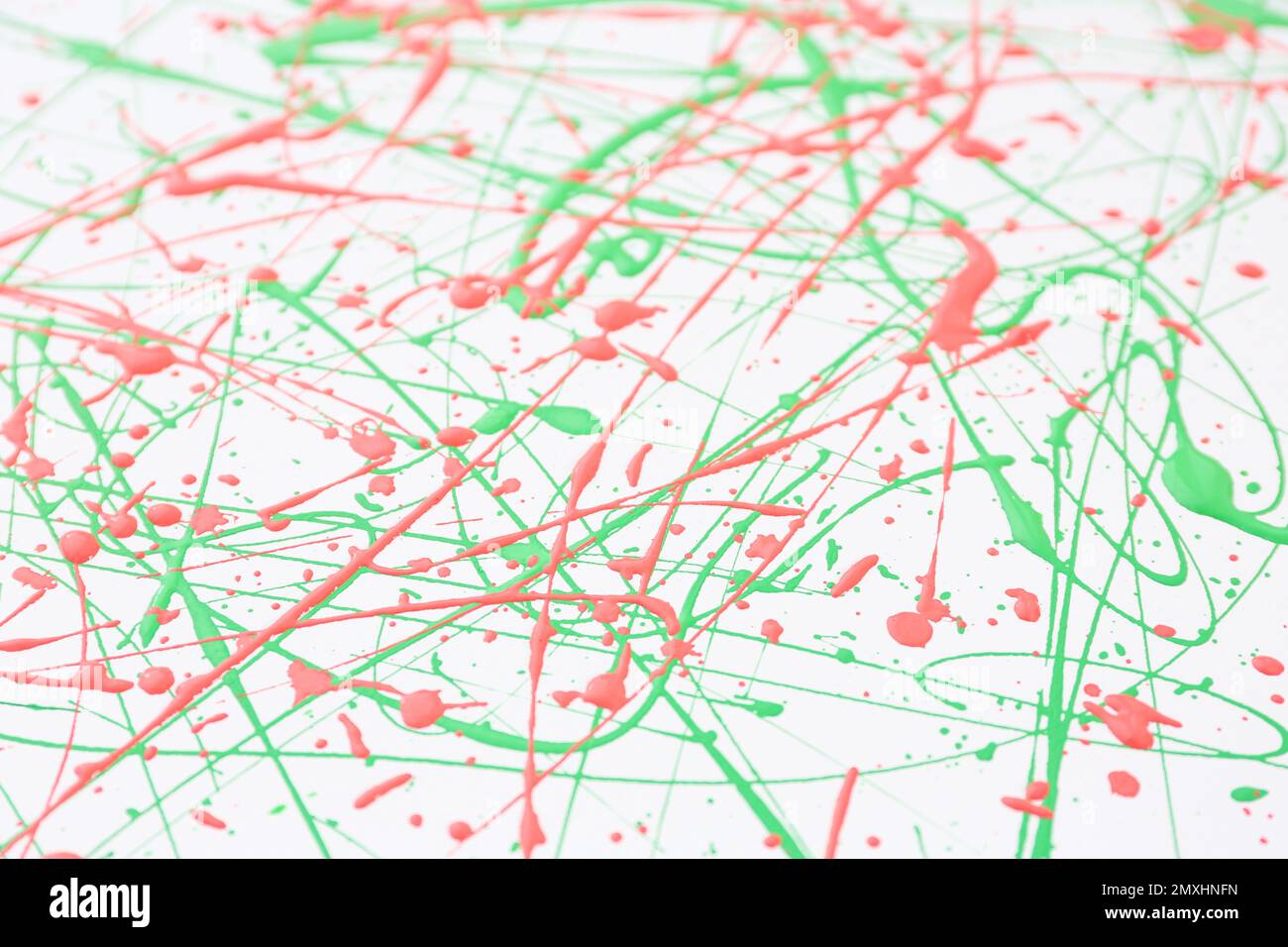 Colorful paint splashes on white canvas as background. Art and ...