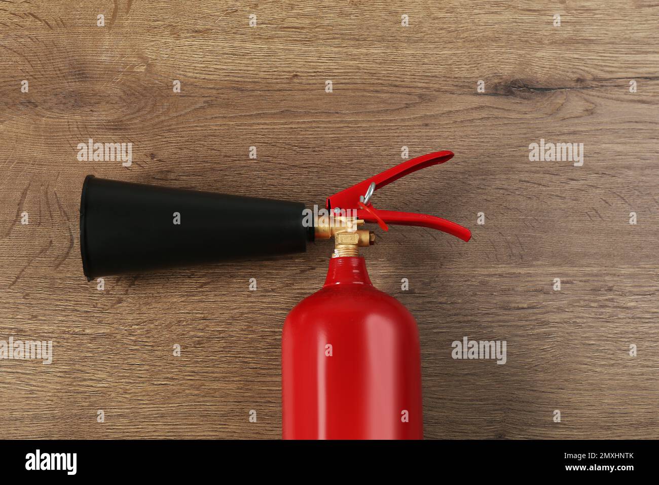Fire extinguisher on wooden background, top view Stock Photo - Alamy