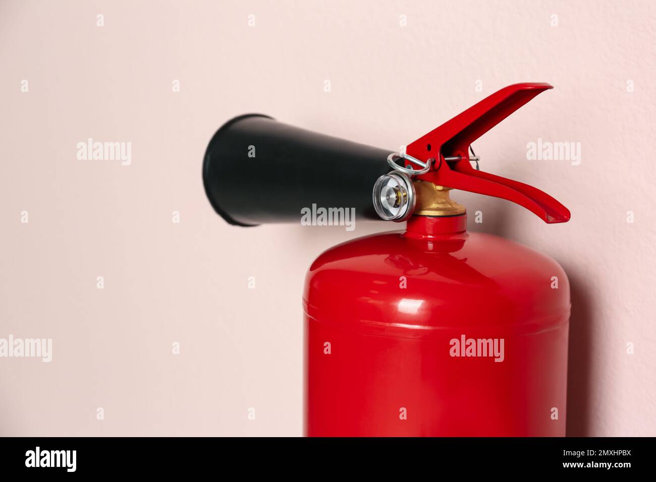 Fire extinguisher on pink background, closeup view Stock Photo - Alamy