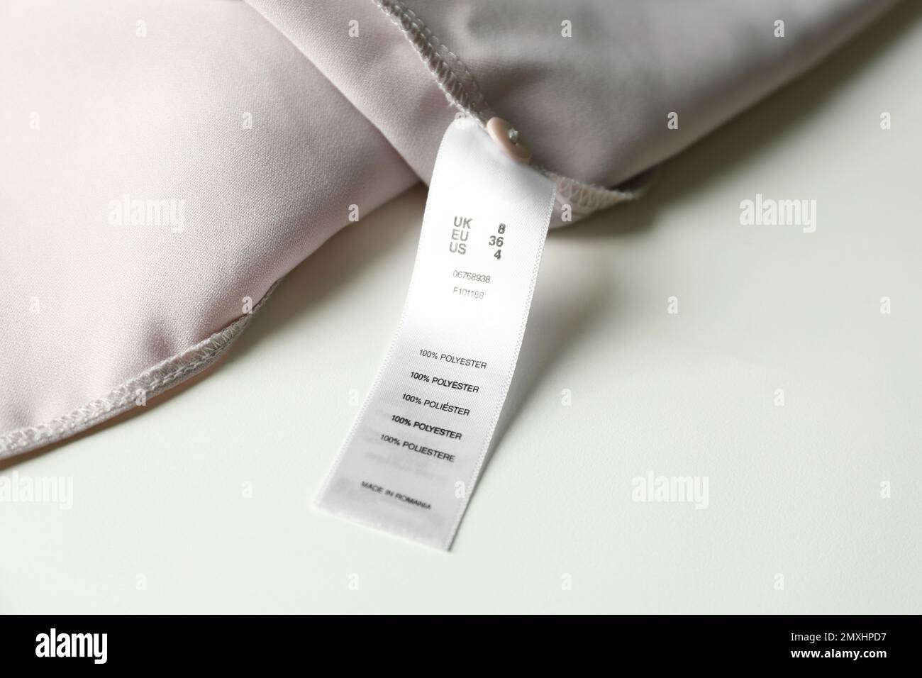 Clothing label with size and content information on light garment ...