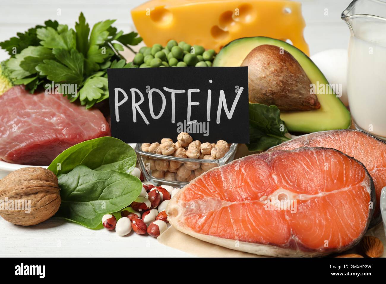 Card with word PROTEIN and different products on table, closeup Stock ...