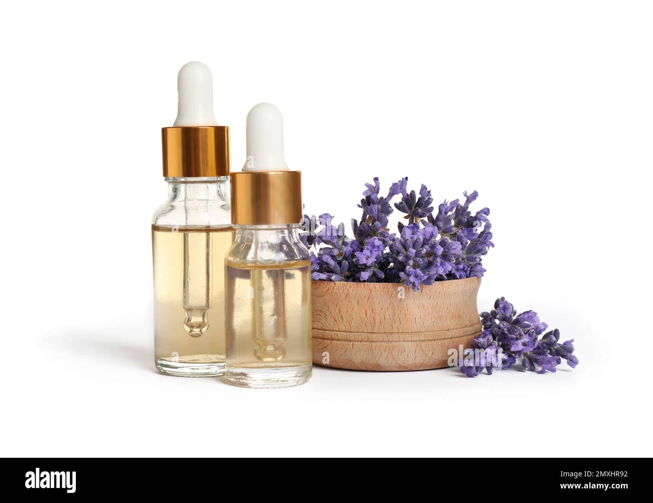 Bottles of essential oil and lavender flowers on white background Stock ...