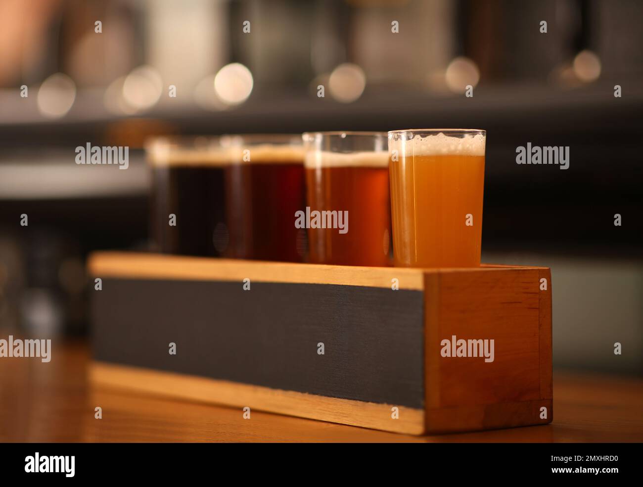 Beer tasting set on wooden bar counter Stock Photo - Alamy