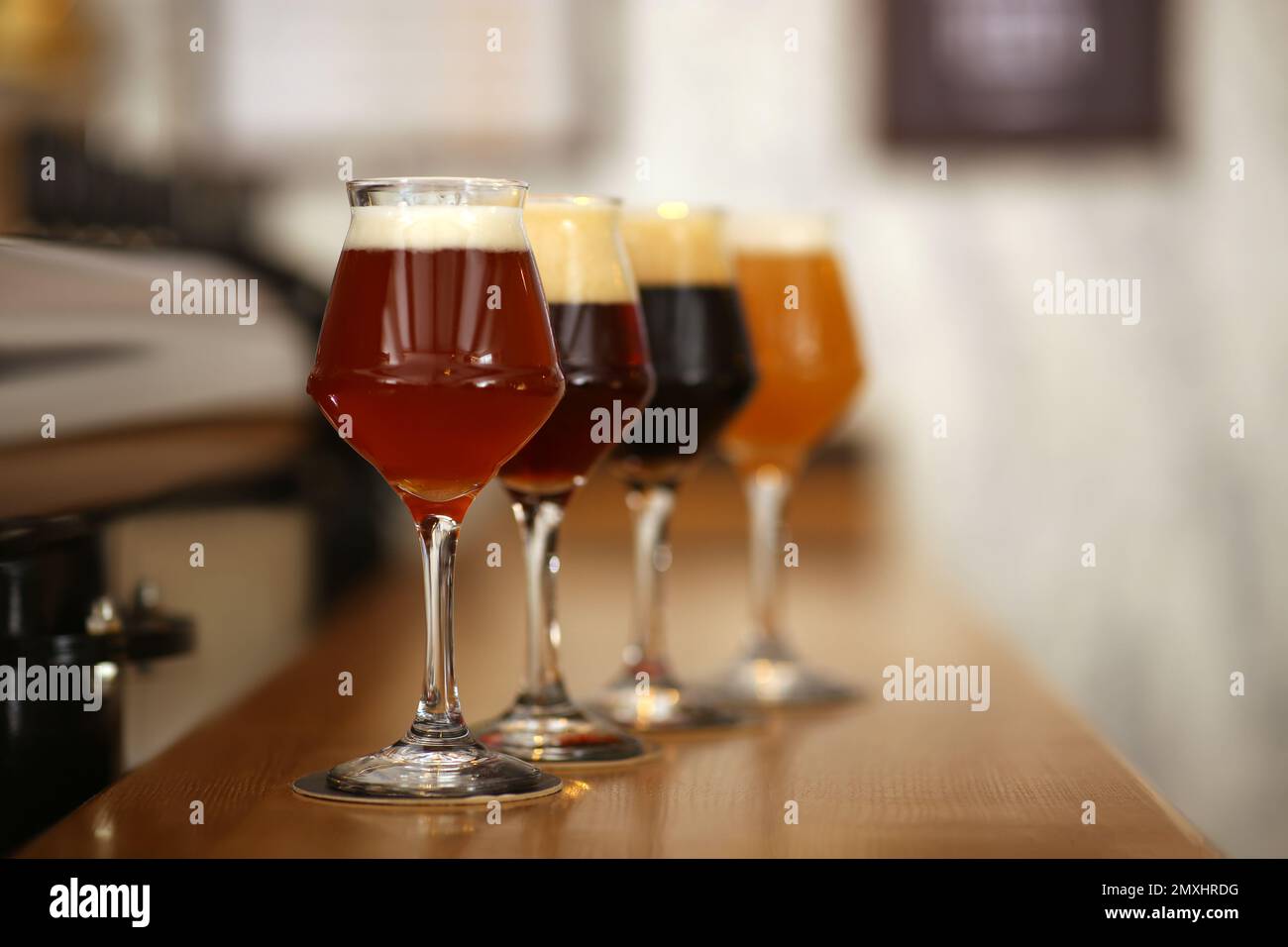 Different beers in glasses on bar counter Stock Photo - Alamy
