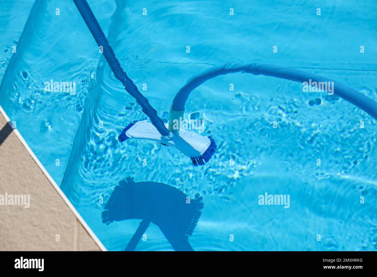 Cleaning outdoor pool with underwater vacuum, closeup Stock Photo - Alamy