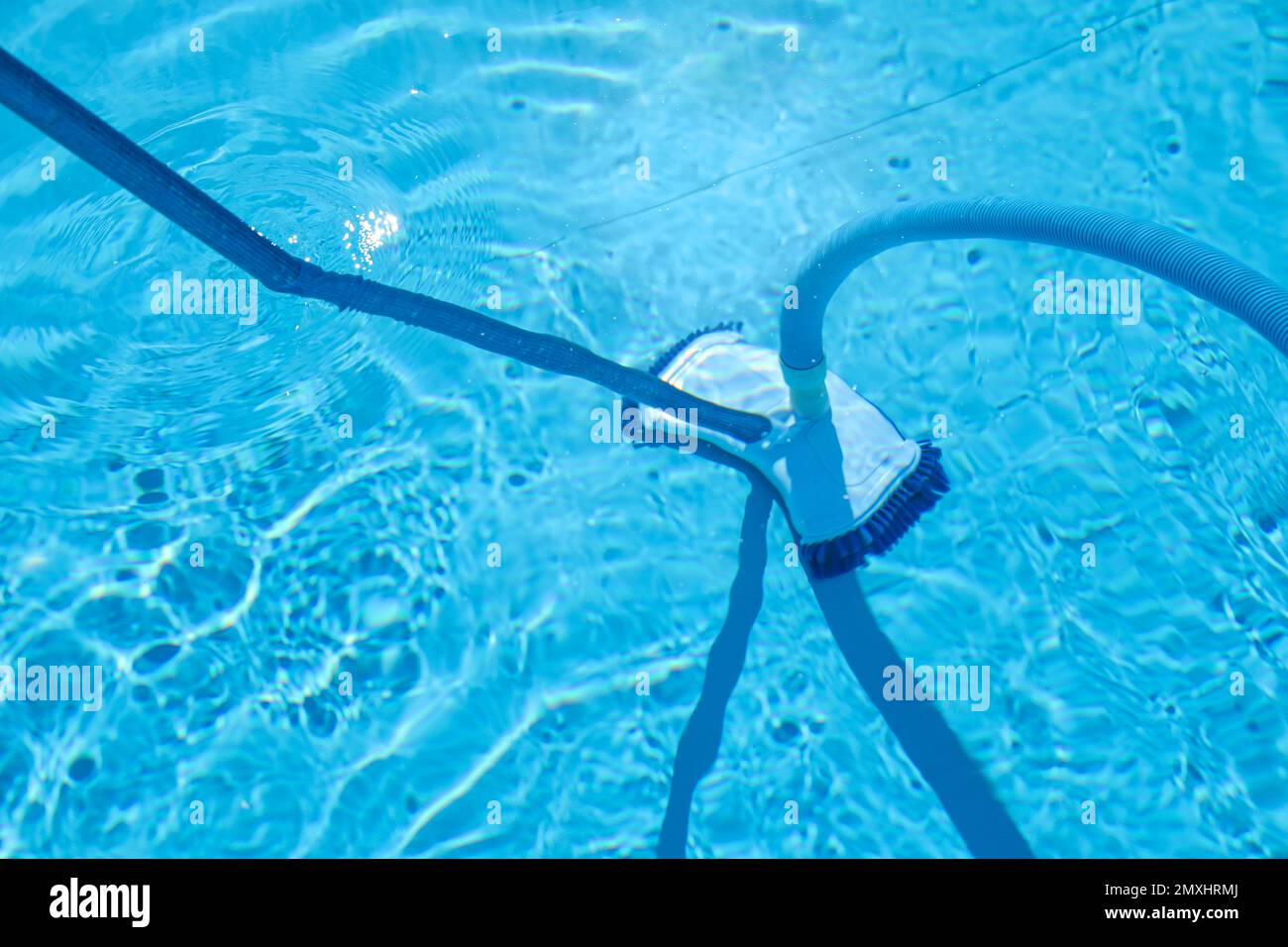Cleaning outdoor pool with underwater vacuum, closeup Stock Photo - Alamy