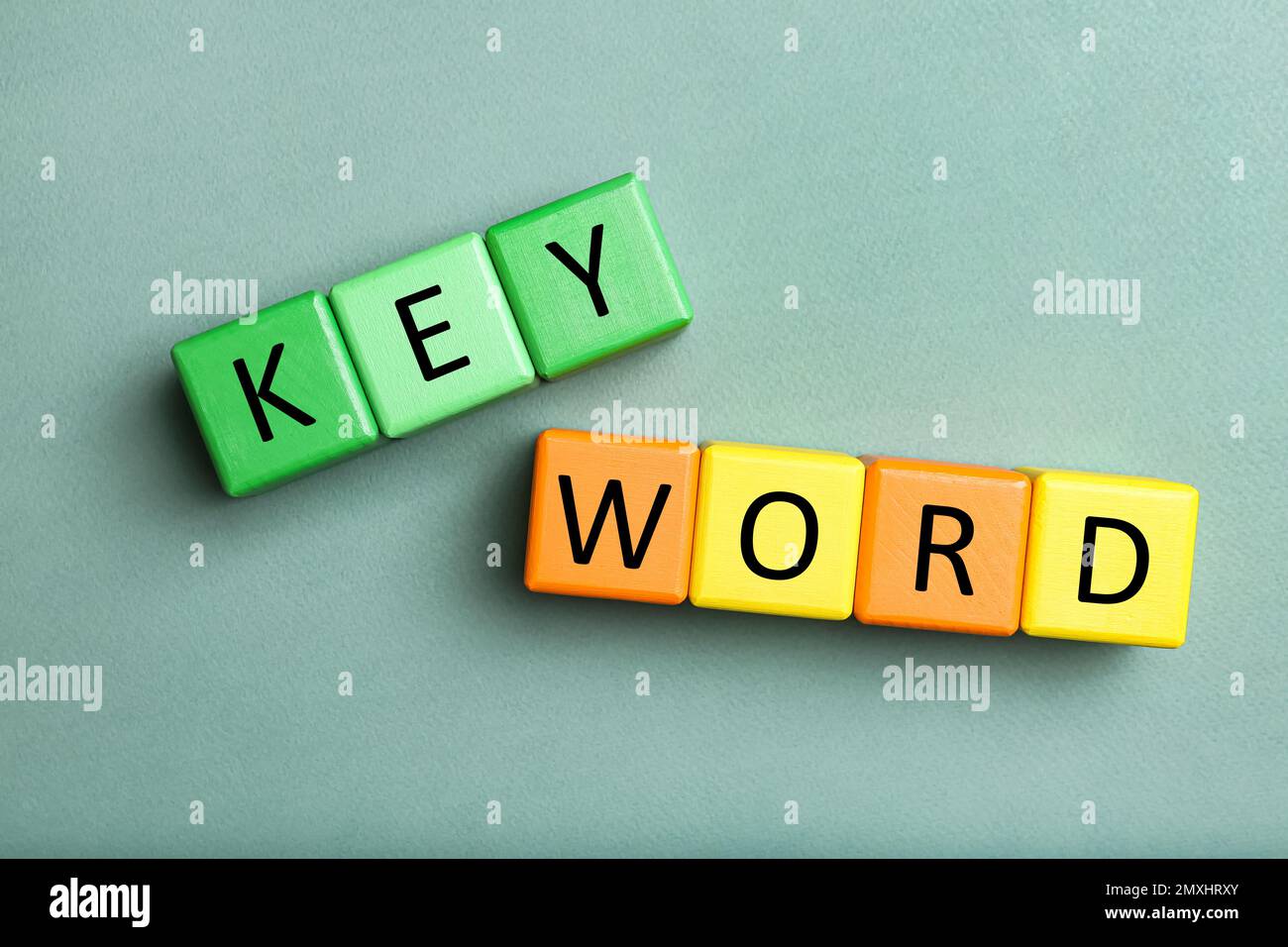 Colorful cubes with word KEYWORD on light green background, flat lay ...