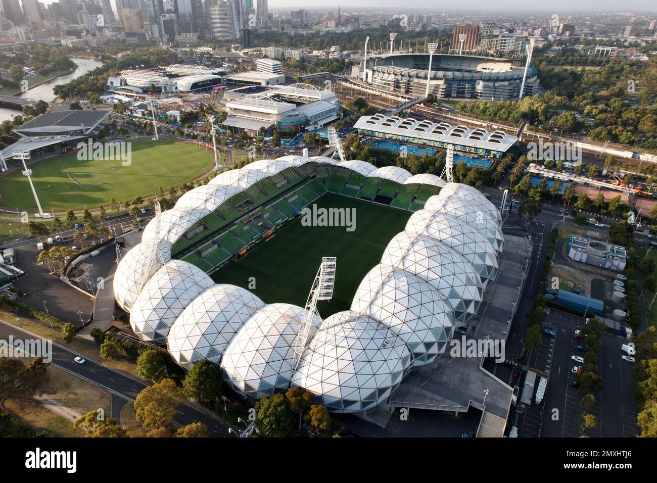 An aerial view of a stadium surrounded by city buildings and a football ...