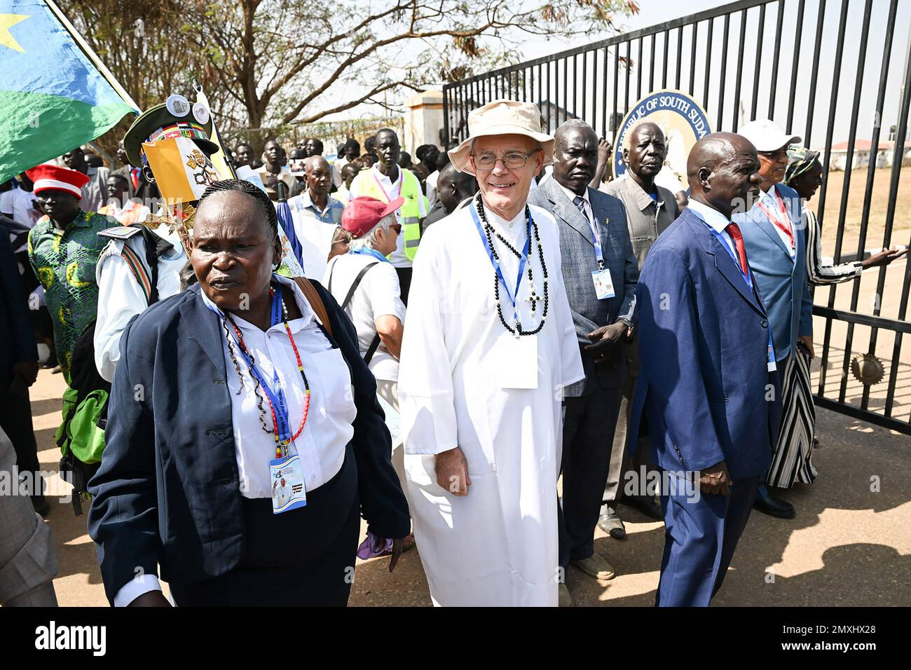 Clergymen wait to welcome Pope Francis upon his arrival at the Juba ...