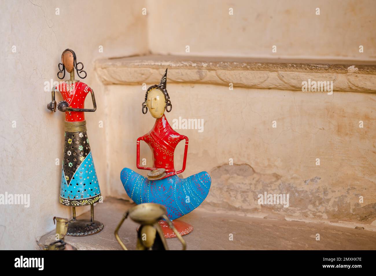 A closeup of metal stick figure dolls on the steps of a stair Stock ...