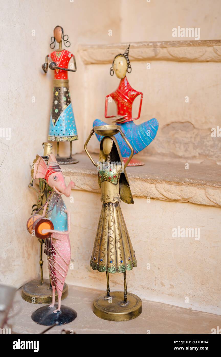 A vertical shot of metal stick figure dolls on the steps of a stair ...