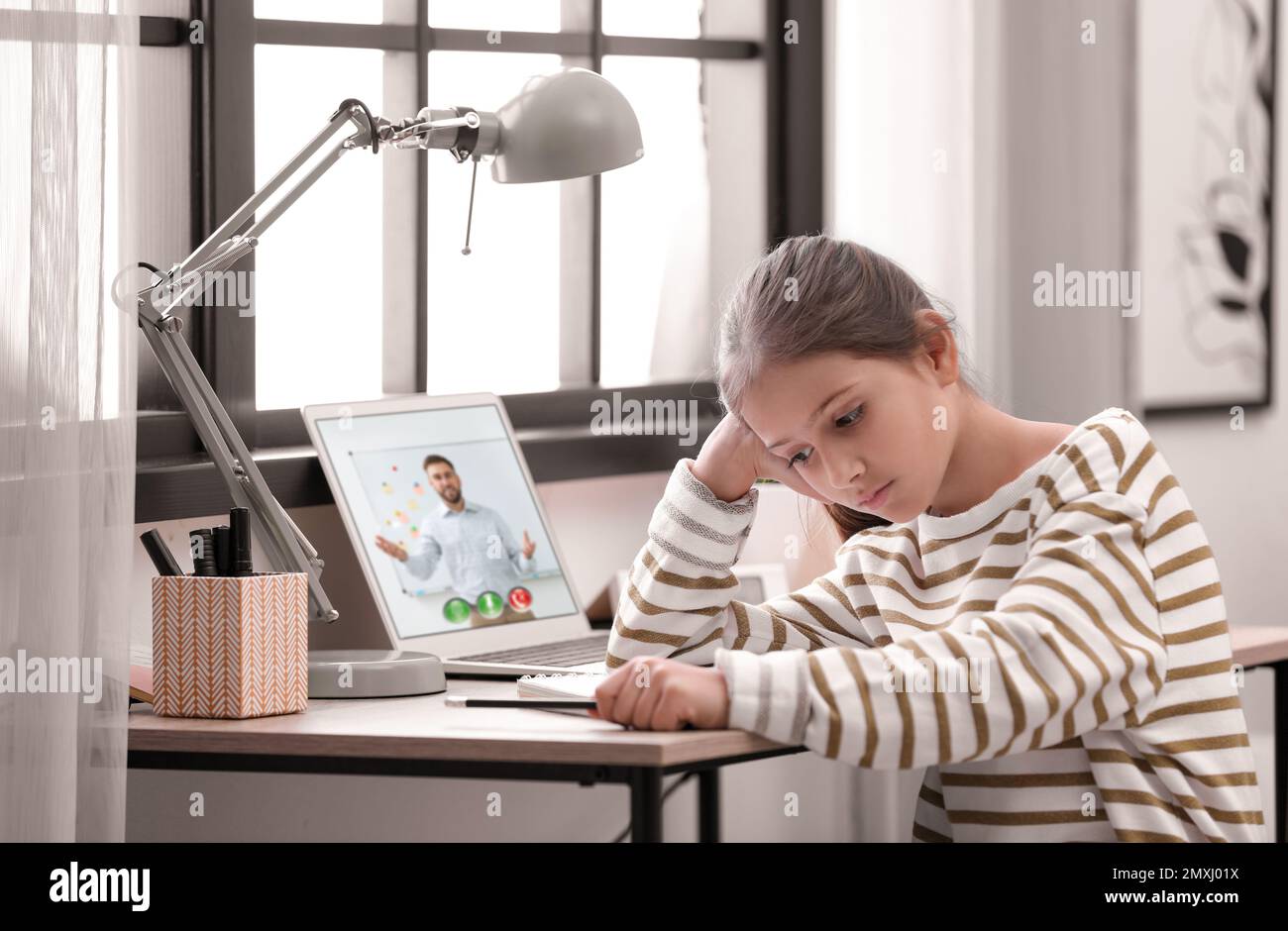Distance learning, online school lesson. Girl studying at home during ...