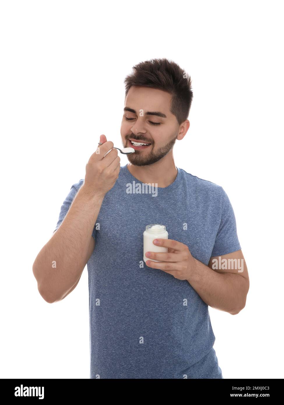 Young man eating yoghurt hi-res stock photography and images - Alamy