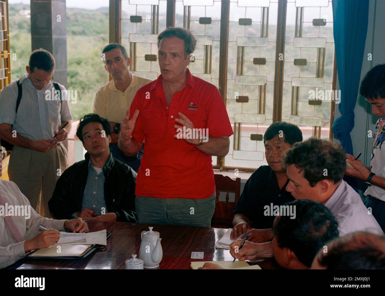 U.S. Assistant Secretary of State Winston Lord, center, gestures as he ...