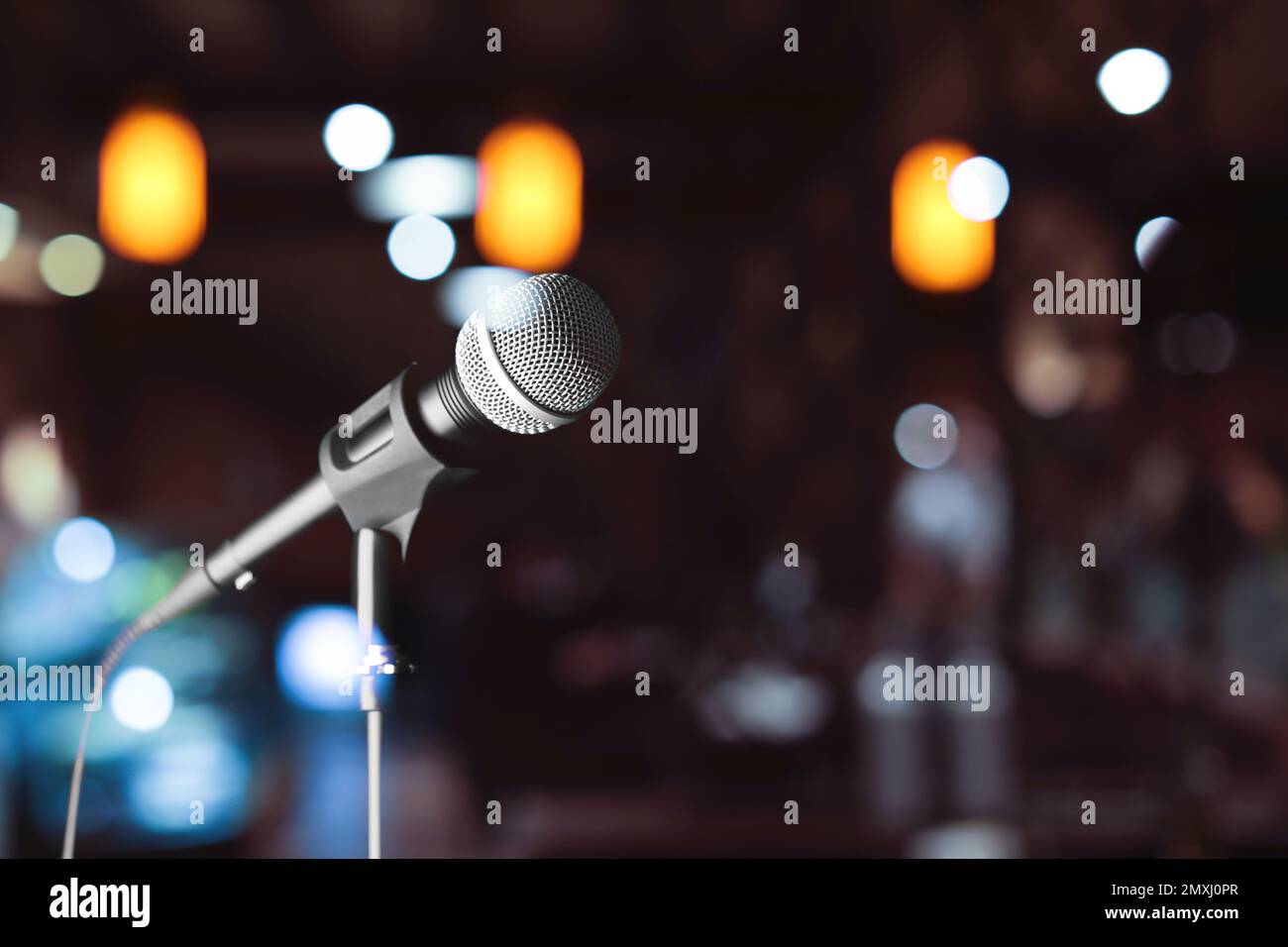 Modern microphone in karaoke club. Space for text Stock Photo - Alamy