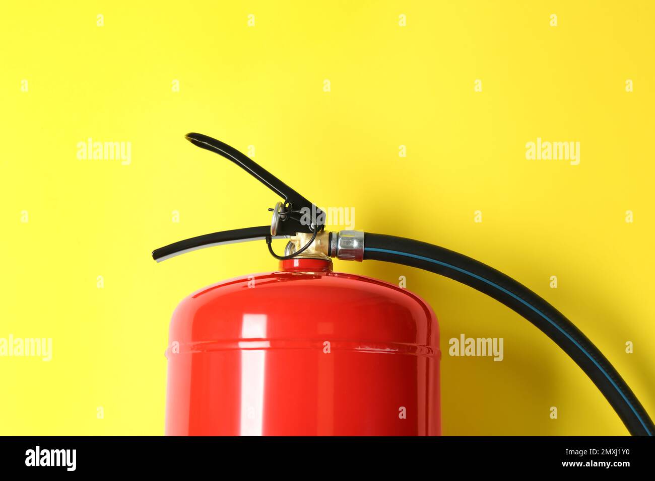 Fire extinguisher on yellow background, top view Stock Photo - Alamy