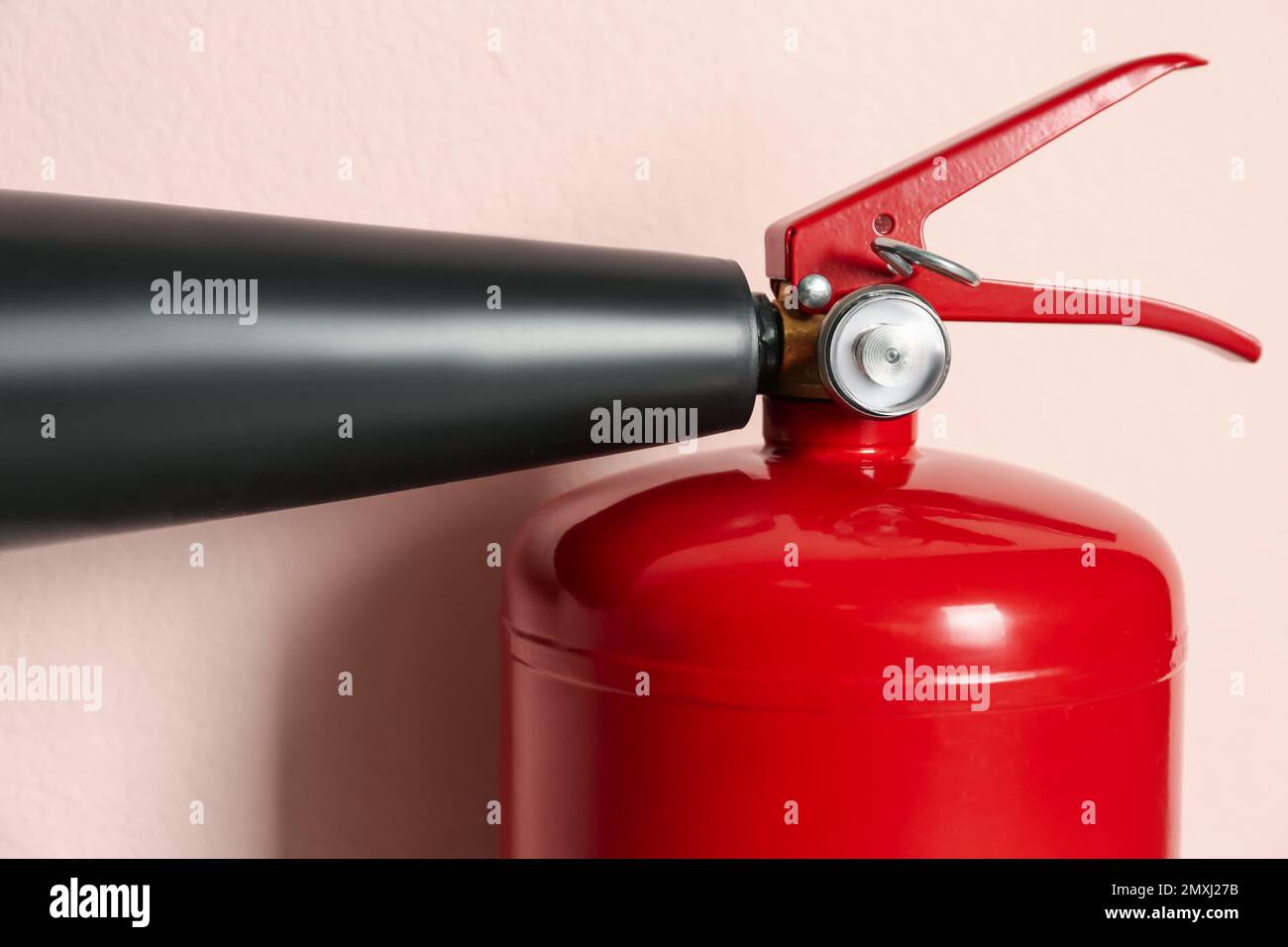 Fire extinguisher on pink background, closeup view Stock Photo - Alamy