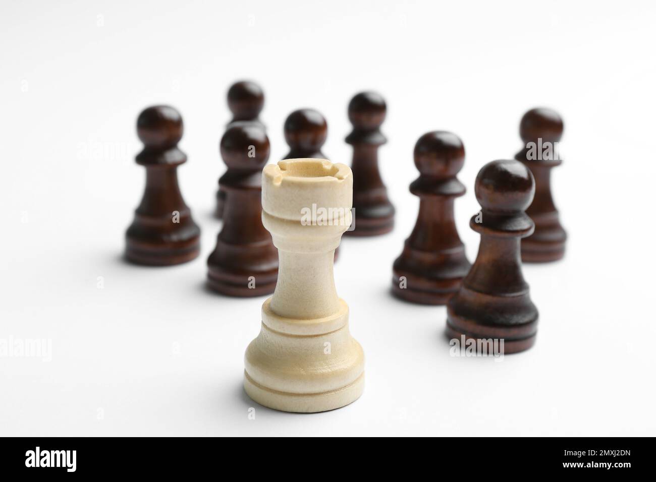 White rook in front of black pawns on light background. Career ...