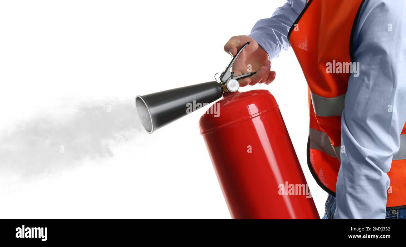 Worker using fire extinguisher on white background, closeup Stock Photo ...