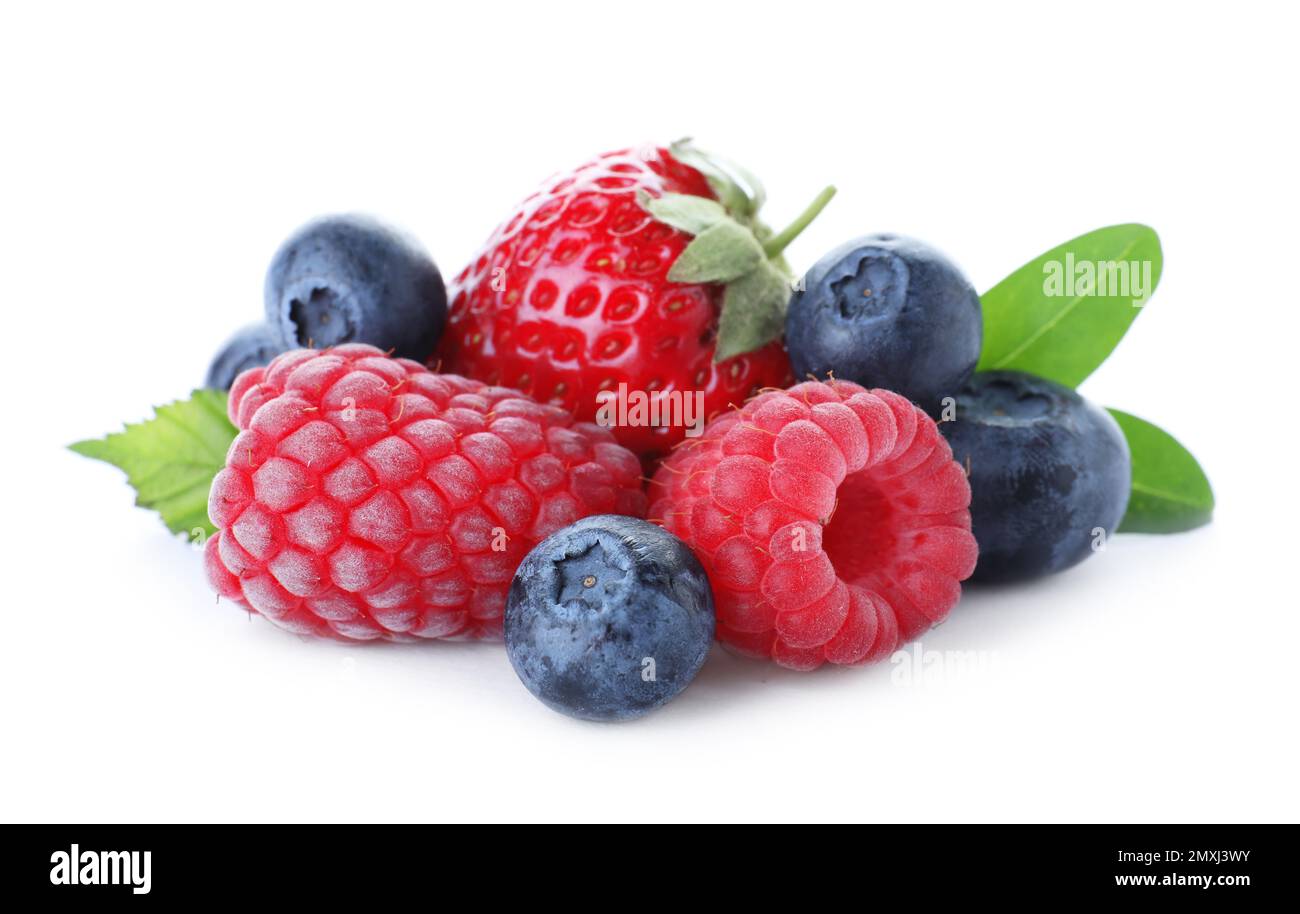 Pile of different ripe tasty berries with green leaves isolated on ...