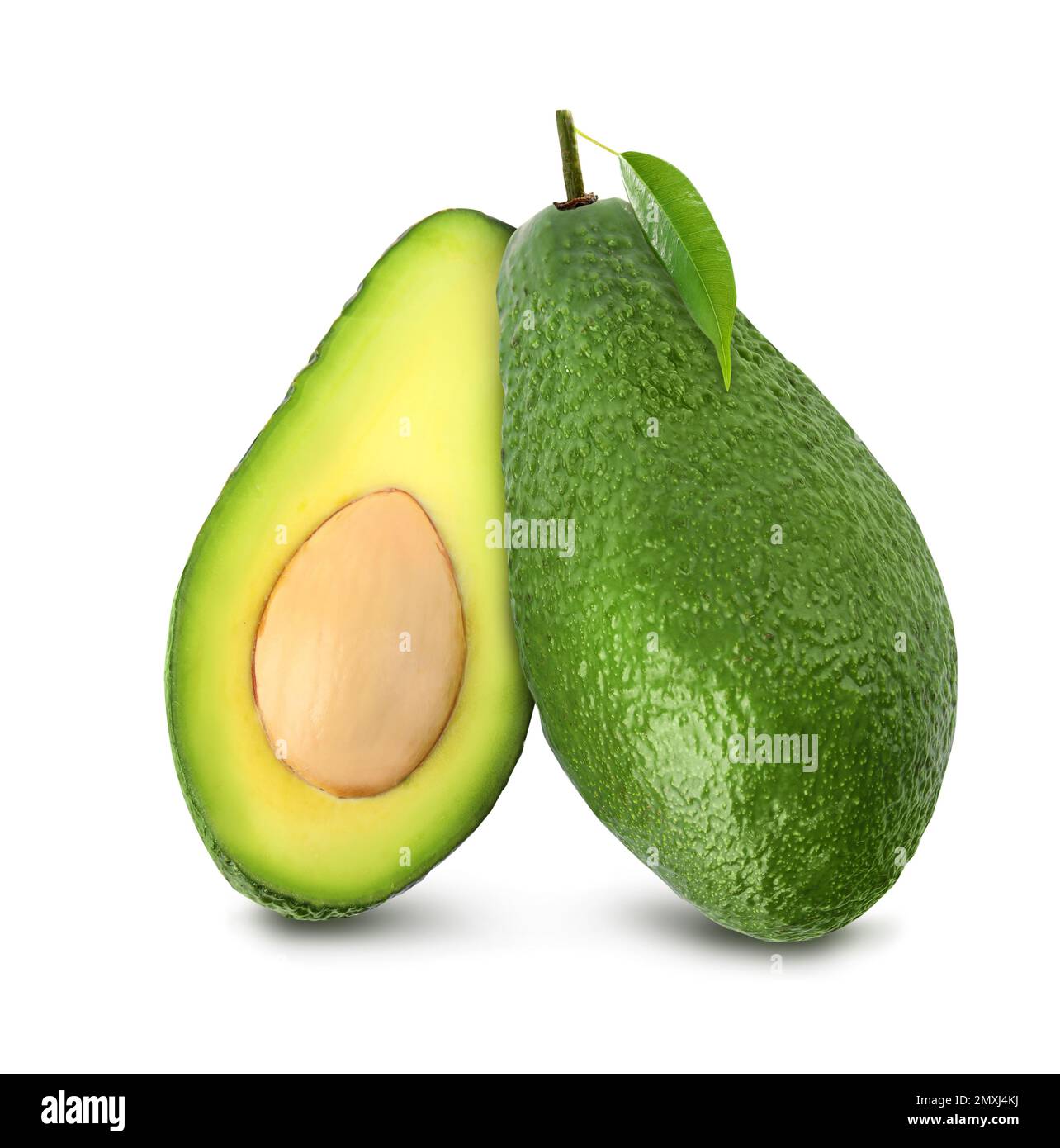 Cut and whole fresh avocados on white background Stock Photo - Alamy