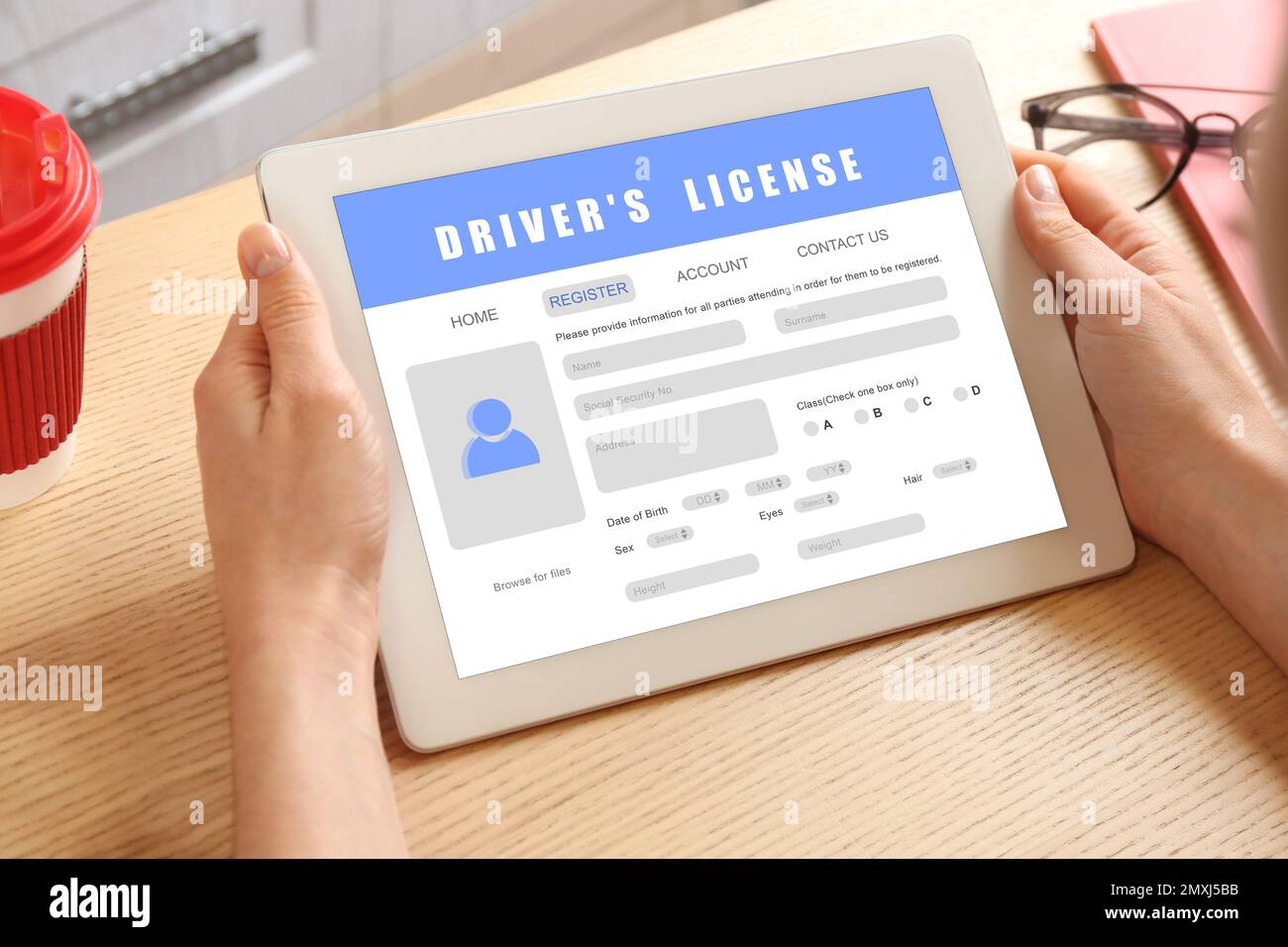 Woman filling in driver's license form online on website using tablet, closeup Stock Photo - Alamy