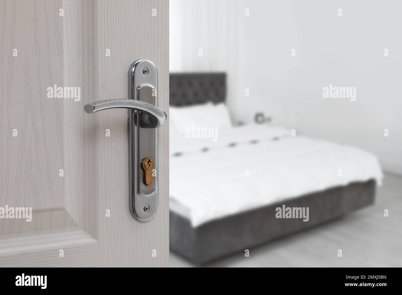 White door open into modern hotel room, closeup Stock Photo - Alamy