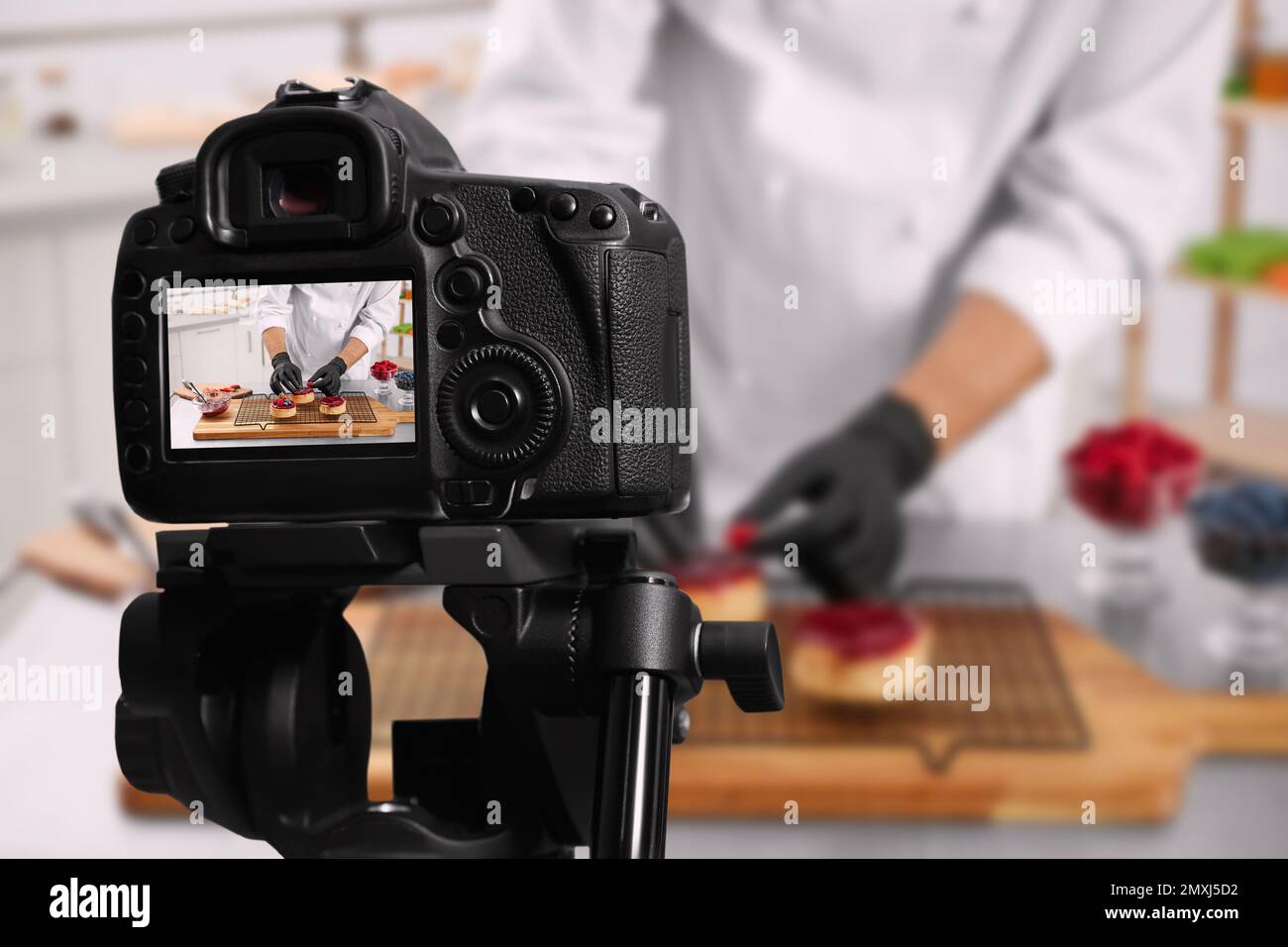 Food photography. Shooting of chef decorating dessert, focus on camera ...