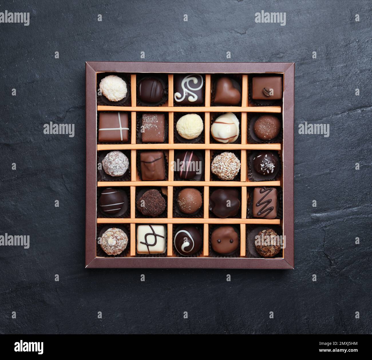 Box with delicious chocolate candies on black table, top view Stock ...