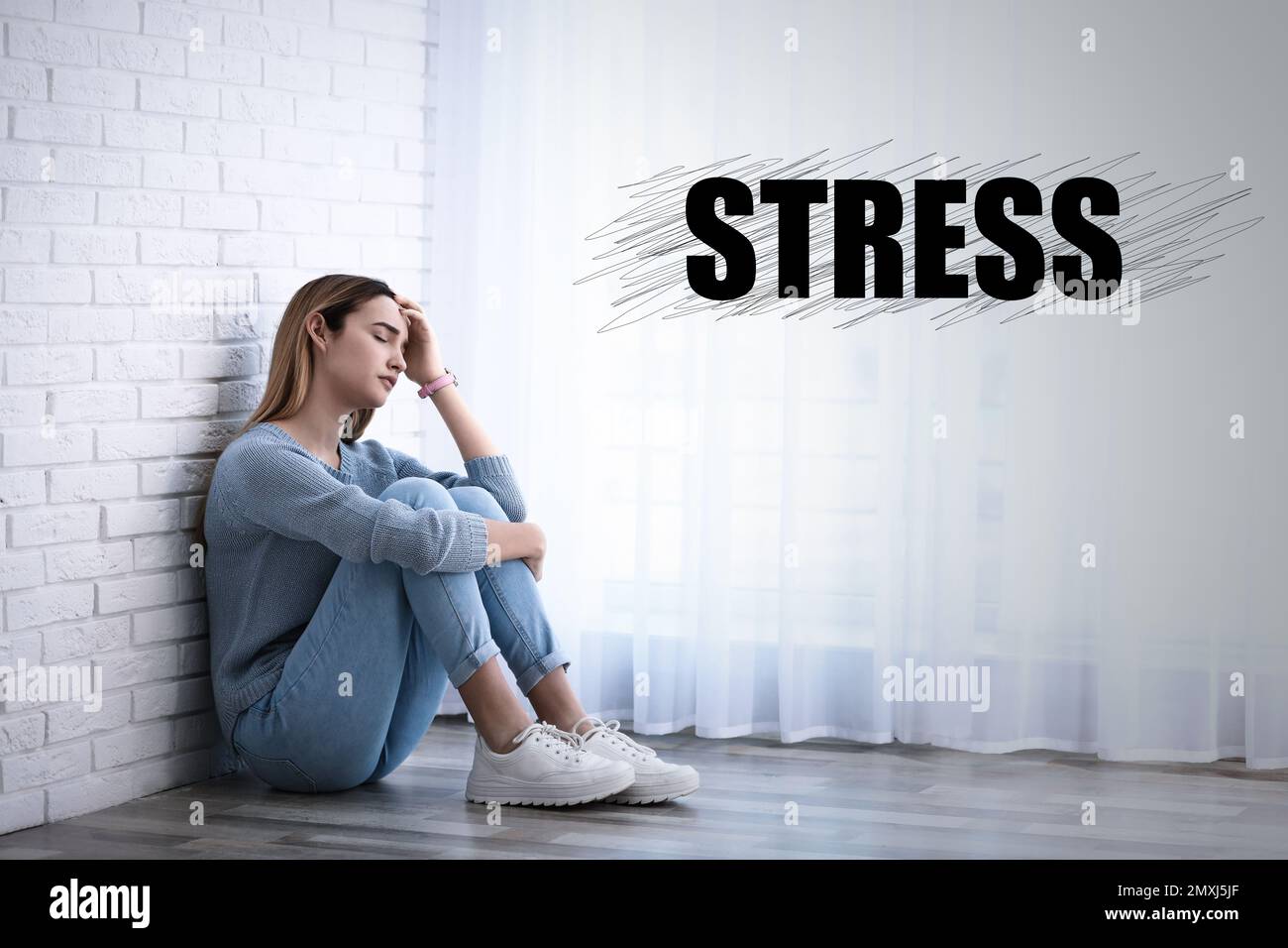 Depressed young girl sitting on floor indoors and word STRESS Stock ...