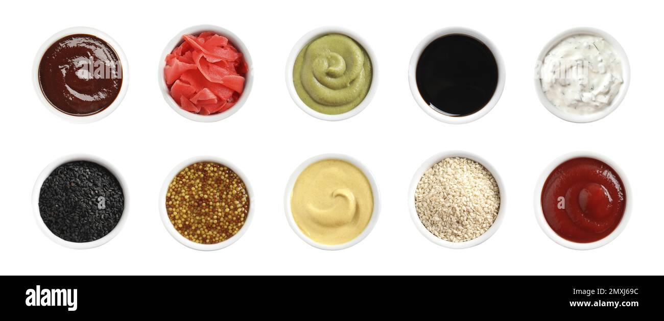 Set of different delicious sauces and condiments on white background ...