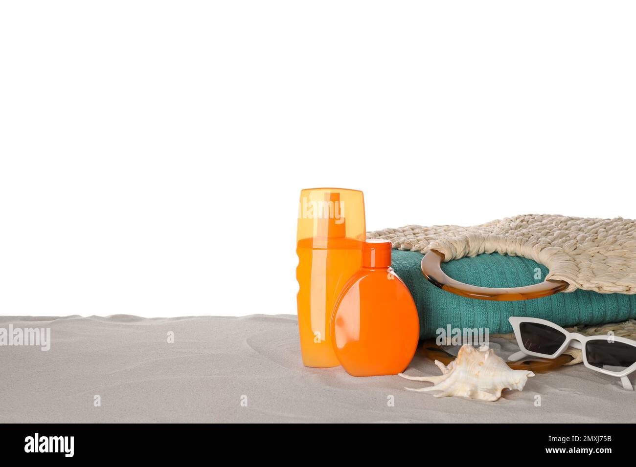 Composition with sun protection products on sand against white ...