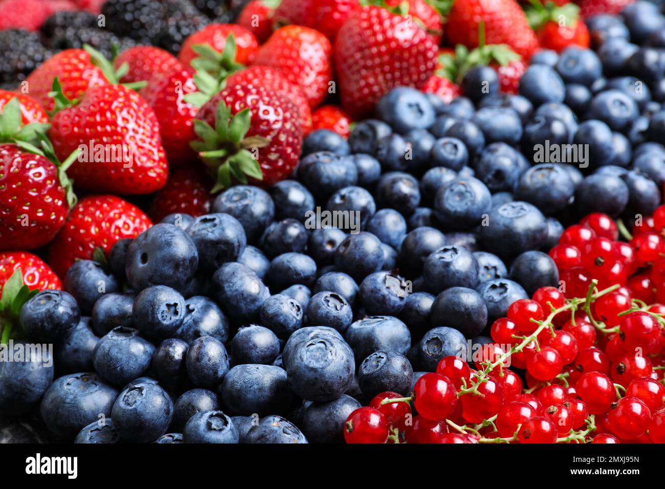 Mix of different ripe tasty berries as background, closeup view Stock ...